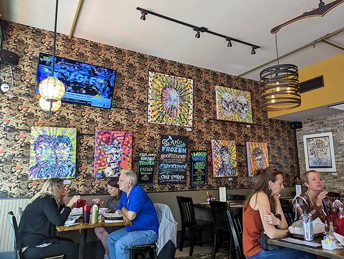 Local art adorns floral wallpaper, creating that perfect New Orleans vibe where tradition and eccentricity aren't just neighbors—they're roommates who get along famously.
