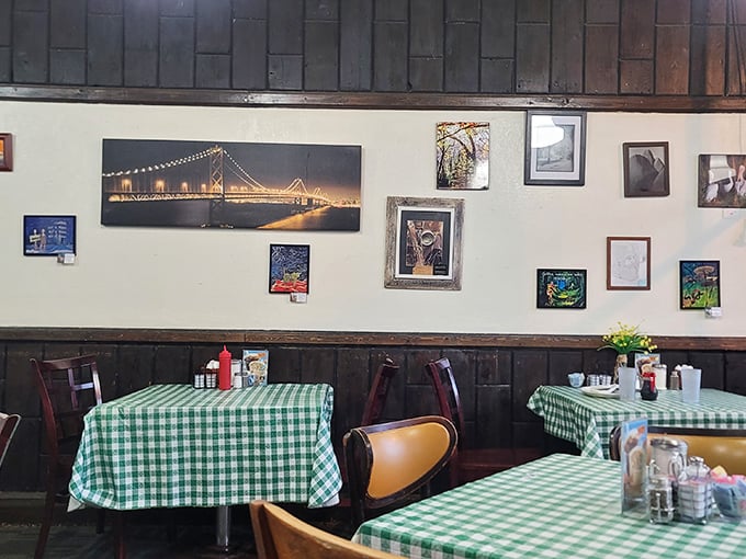 The wall art collection isn't random—it's a community scrapbook. That bridge photo reminds you there's a world outside, but why leave?