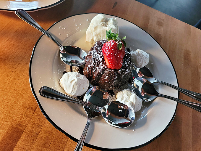 Chocolate decadence surrounded by whipped cream islands – a dessert that demands multiple spoons and zero conversation until it's gone.
