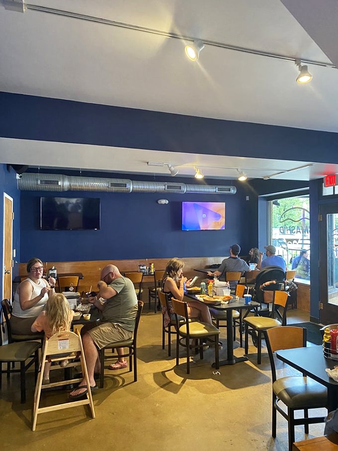 Happy diners lost in conversation and burger bliss. Notice how nobody's on their phones? That's the universal sign of food worth paying attention to.
