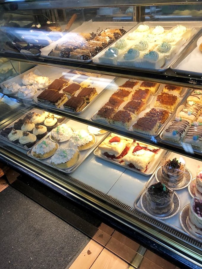The bakery case—where dreams and calories live in perfect harmony. Each tray holds the potential to turn a bad day completely around.
