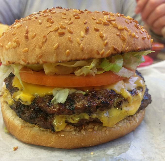 This isn't just a burger—it's an architectural marvel of beef, cheese, and green chiles that requires both hands and zero shame.