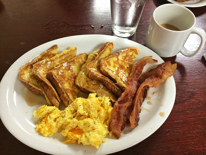 French toast that makes Wonder Bread transcend its humble origins. Crisp edges, custardy centers, and maple syrup creating breakfast's golden hour.