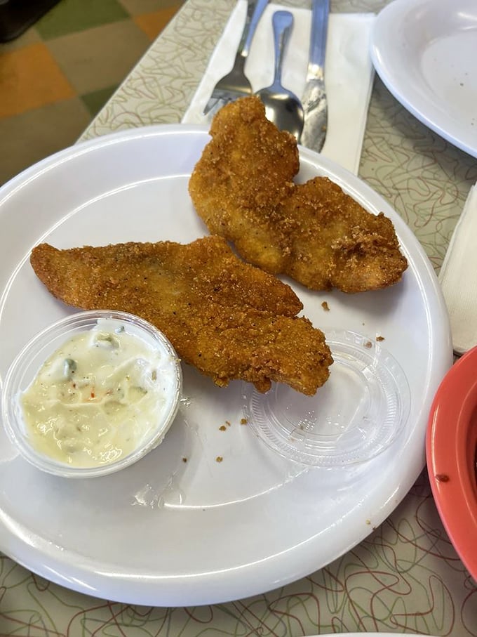 Crispy catfish strips with homemade tartar sauce—Southern seafood simplicity that makes you wonder why anyone would bother with fancy restaurants.