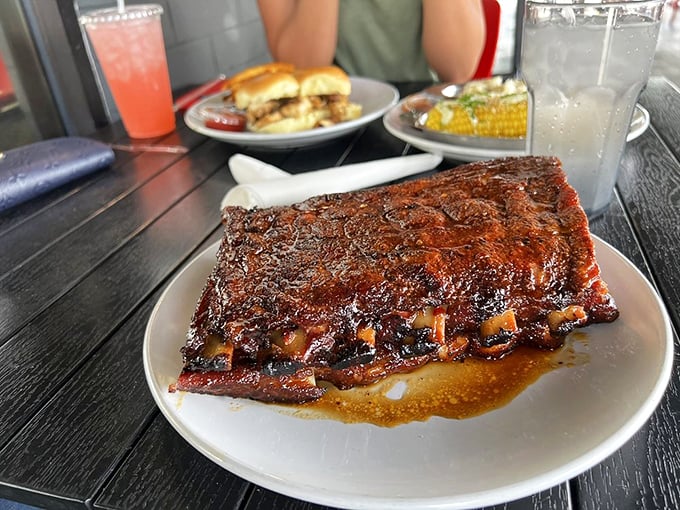 A full rack of ribs glistening with sauce – the kind of sight that makes vegetarians question their life choices.