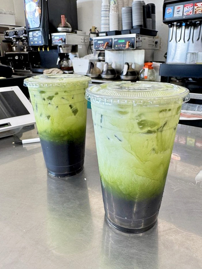 These green Thai tea drinks look like science experiments gone deliciously right—layers of vibrant color promising exotic refreshment with every sip.