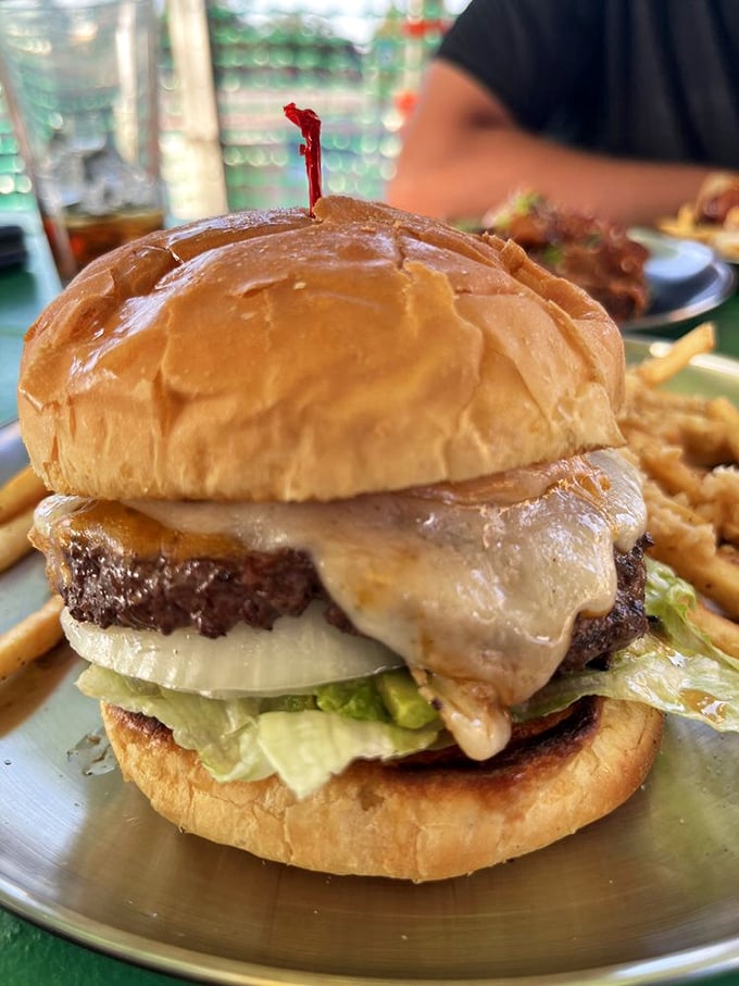 This isn't just a burger – it's architecture. The melted cheese cascading down the sides creates a mouthwatering monument to beef.