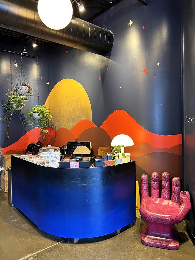 The host station welcomes visitors with a cosmic landscape mural and—is that a pink hand chair? This place understands personality matters as much as pancakes.