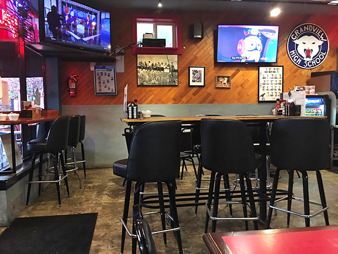 Bar seating that gives you front-row tickets to the breakfast show. The wood paneling and TVs create that perfect "neighborhood living room" vibe.