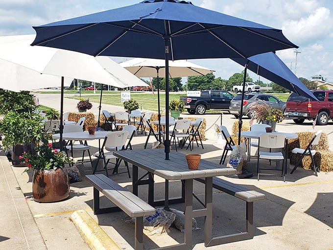 The outdoor patio offers al fresco dining with a side of Midwestern practicality—umbrellas for shade, hay bales for ambiance.