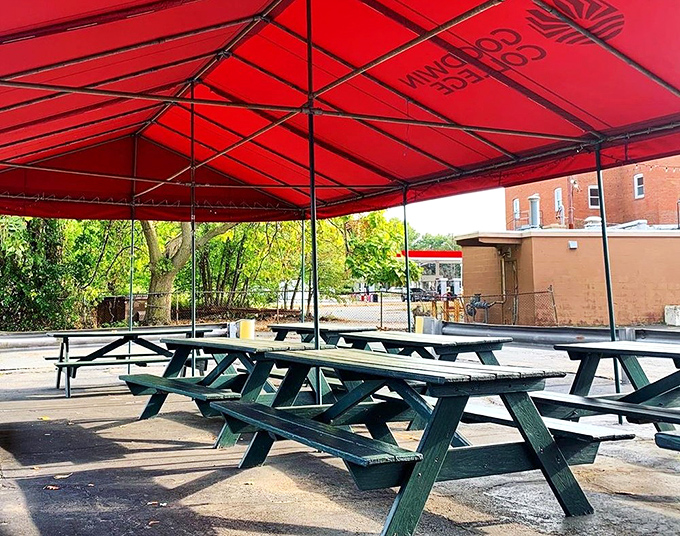 The outdoor patio – where picnic tables under a red canopy create the perfect summer setting for enjoying those legendary fries.