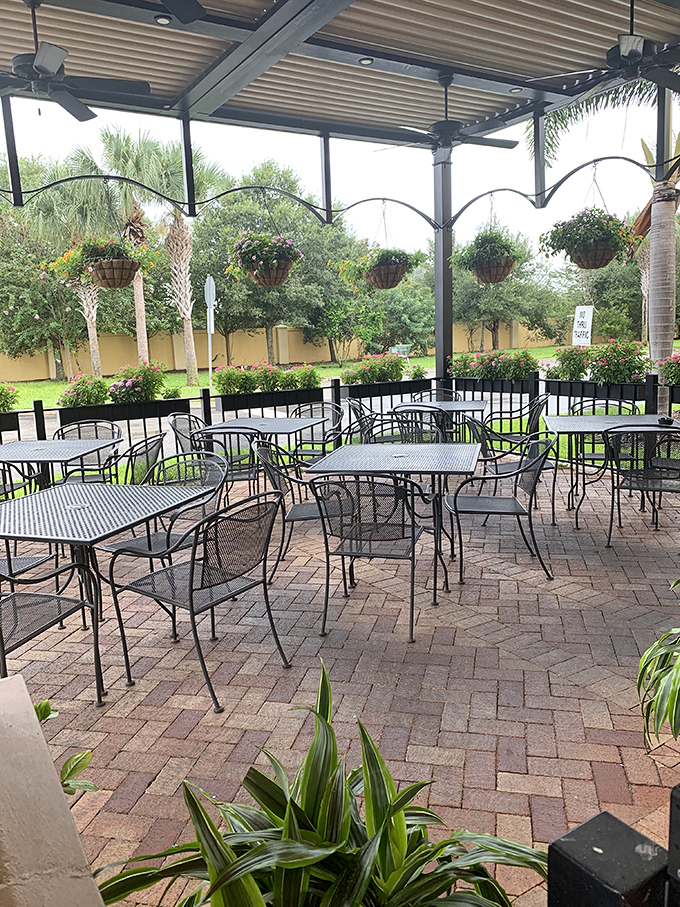 Florida sunshine meets British leisure. The covered patio offers al fresco dining with hanging plants—something you'd rarely enjoy in actual British weather.