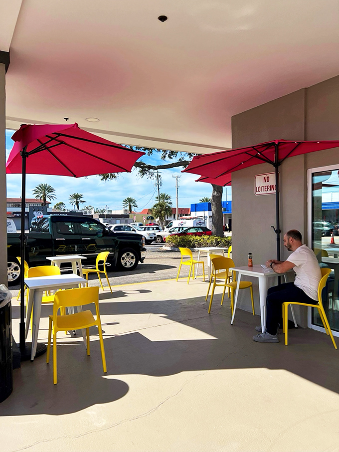 Sunshine, red umbrellas, and yellow chairs – the outdoor seating area where you can enjoy your pastry with a side of vitamin D.