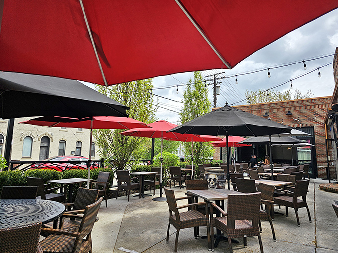 Red umbrellas pop against the Cleveland sky, creating an outdoor oasis where string lights promise good times will continue past sunset.