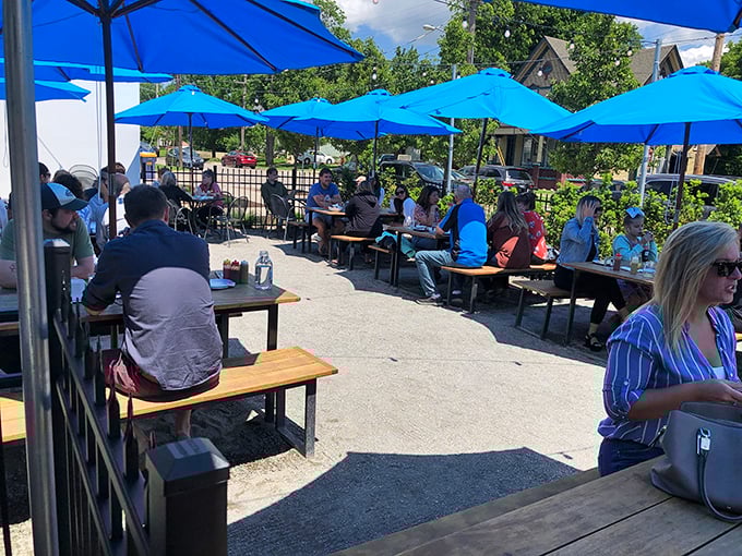 Blue umbrellas create islands of shade where Michigan summer days are best spent contemplating the serious business of which taco to order next.