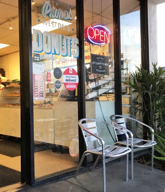 Two chairs, infinite possibilities. This modest entrance has welcomed donut enthusiasts from all walks of life for generations.