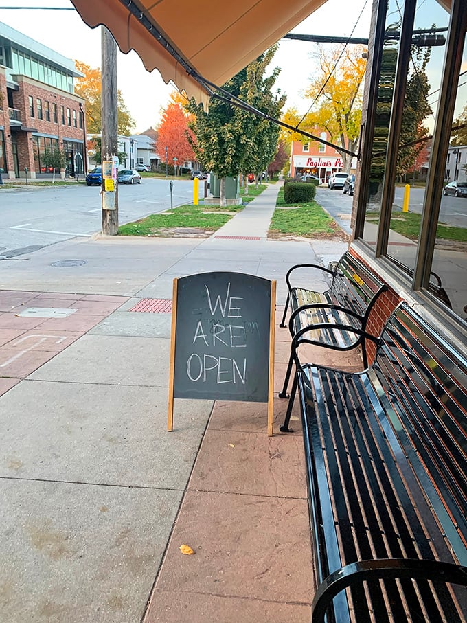 "We Are Open" – three words that have never looked more inviting. The simple sidewalk welcome that promises comfort food salvation just steps away.