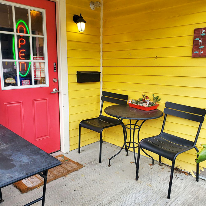 The front porch seating area where time slows down just enough to savor every bite. That yellow wall and red door combo is Kentucky's answer to European café culture.