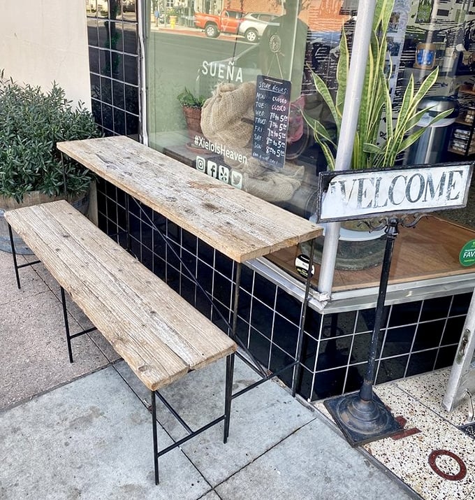 The rustic outdoor bench offers prime real estate for pastry consumption and people-watching—urban dining at its most charming.