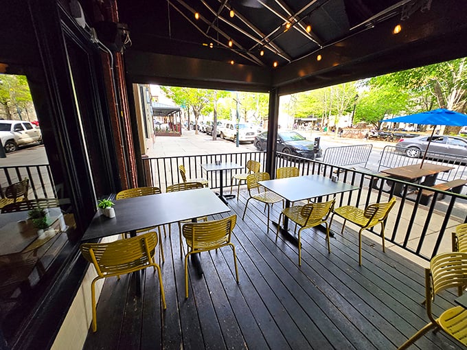 Outdoor seating that lets you people-watch while you biscuit-watch—a perfect Asheville afternoon in bright yellow chairs.