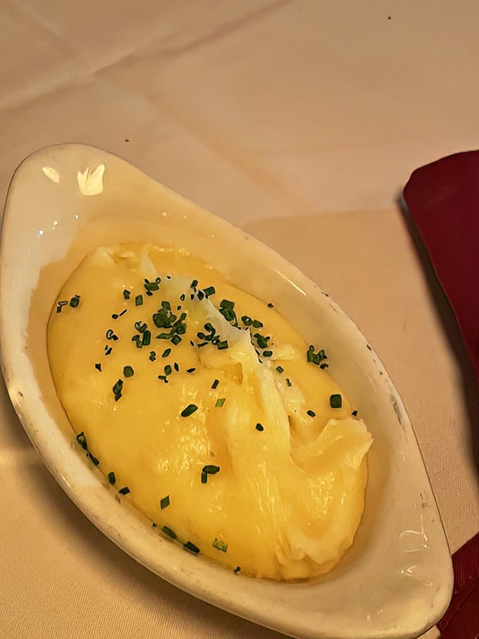 Pommes purée so silky and buttery it makes mashed potatoes seem like a completely different food group. Those chives aren't just garnish—they're necessary.