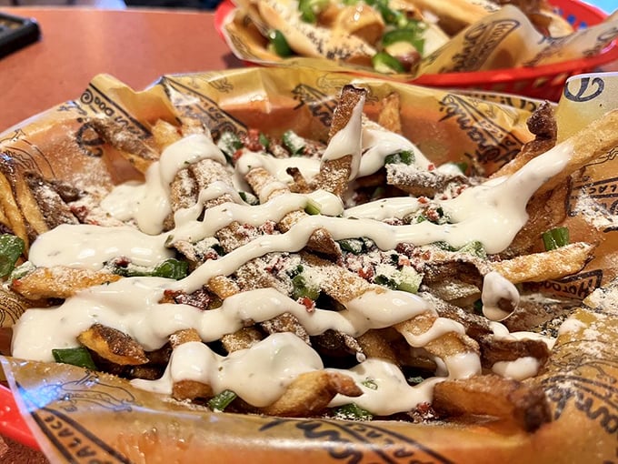 These aren't mere fries—they're potato pillars drizzled with ranch and speckled with green onions, transforming the humble spud into something divine.