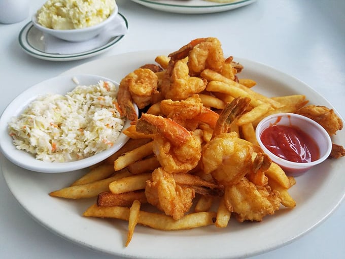 Golden-fried shrimp that snap with freshness, served with crispy fries and creamy coleslaw—Florida's coastal bounty on full display.