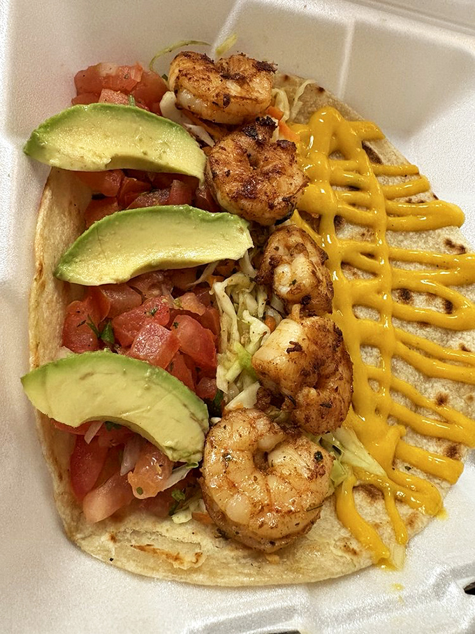 Ocean meets corn tortilla in this shrimp taco masterpiece. The yellow sauce zigzag isn't just for looks—it's the flavor highway to happiness.