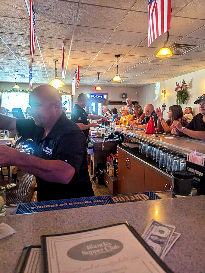 Behind the bar, the real magic happens – where bartenders remember your usual and pour with the precision of seasoned artists.