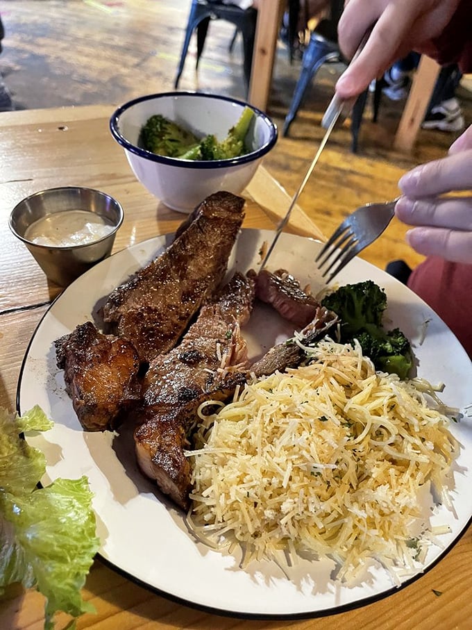 Steak strips that mean business, served alongside pasta that's been thoroughly cheesified – a plate that says "you won't need dinner tonight."