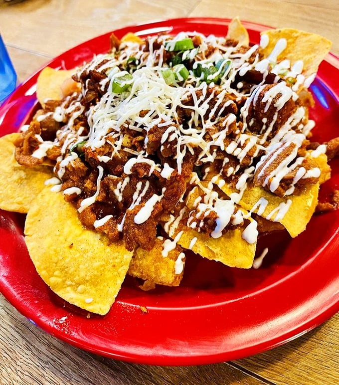 Nachos that refuse to be an afterthought. Crisp tortilla chips become the foundation for a mountain of savory toppings and zigzags of cool sour cream.