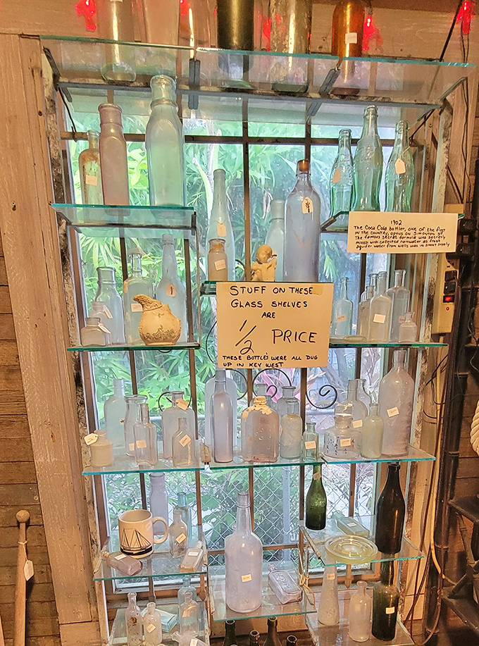 "Stuff on these glass shelves 1/2 price" announces the handwritten sign among bottles excavated from Key West soil – each one containing ghosts of island history.
