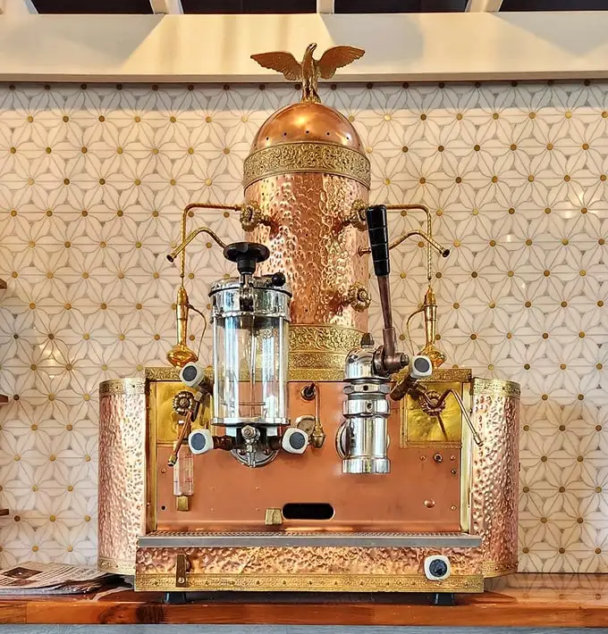 That copper espresso machine isn't just equipment—it's functional art. Coffee made here isn't just served; it's presented with reverence.