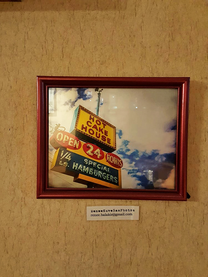 The framed vintage sign photo serves as both art and historical document—proof that some things in Portland should never change.