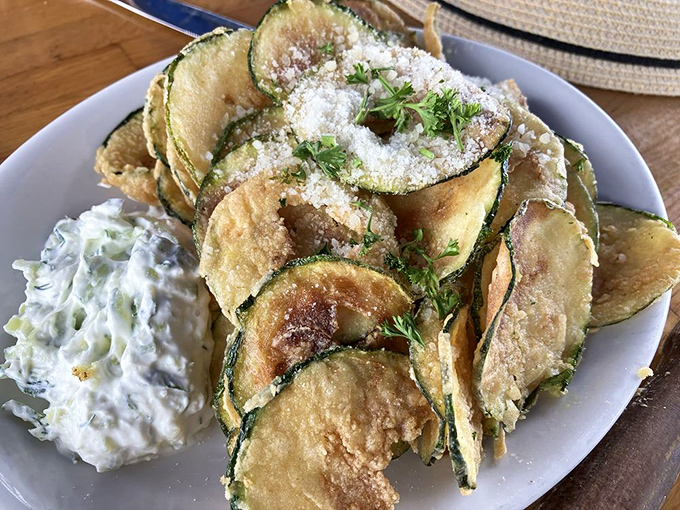 Zucchini chips dusted with kefalotiri cheese that will ruin potato chips for you forever. The tzatziki dip is not optional – it's essential.