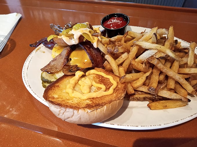 This bacon cheeseburger isn't just food—it's architecture. The pickle slices stand guard like sentinels protecting a treasure of beef and cheese. 