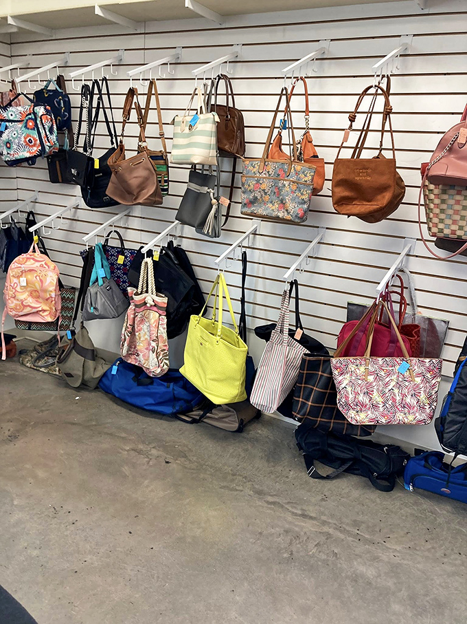 Handbag heaven for the accessory enthusiast—a rainbow of leather, canvas, and possibilities hanging in patient formation.