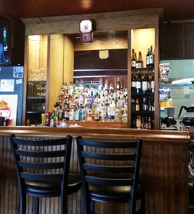 The bar at Eddie's – where morning mimosas transition seamlessly to evening cocktails, all served with equal parts skill and friendly banter.