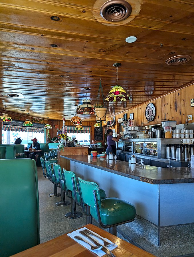 Turquoise bar stools line up like faithful soldiers, ready for the next wave of hungry patrons seeking counter-service wisdom.