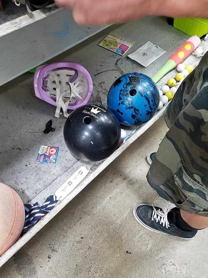 Bowling balls and sports equipment await their next game night hero—proof that one person's abandoned hobby is another's weekend passion.