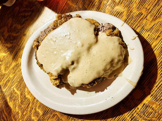 Chicken fried steak swimming in gravy—because sometimes you need a dish that requires both a fork and a life preserver.