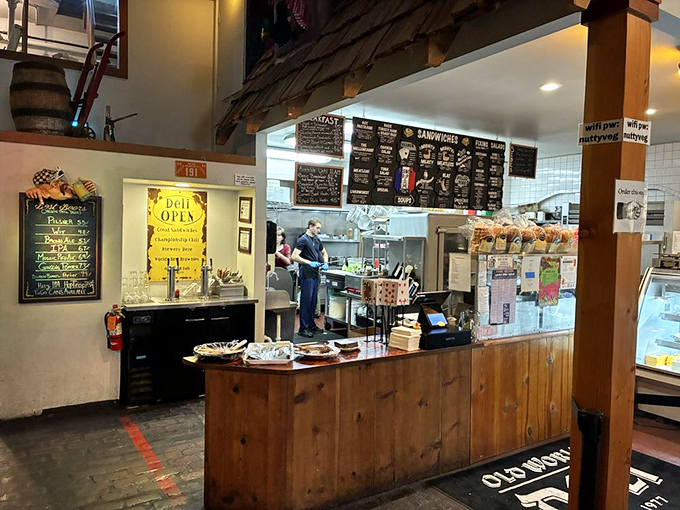 Where sandwich magic happens – the wooden counter and blackboard menu create that perfect blend of rustic charm and culinary anticipation.