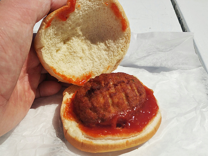 The humble crab cake sandwich—where Maryland tradition meets Delaware execution in a handheld celebration of Atlantic seafood excellence.