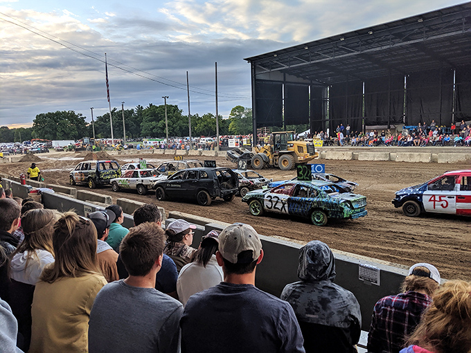 Demolition derby night brings mechanical gladiators to the arena – where automotive destruction becomes performance art for an appreciative crowd.