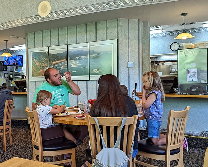 Family breakfast moments that become core memories. That coastal artwork isn't just decoration—it's a preview of your post-pancake adventure.