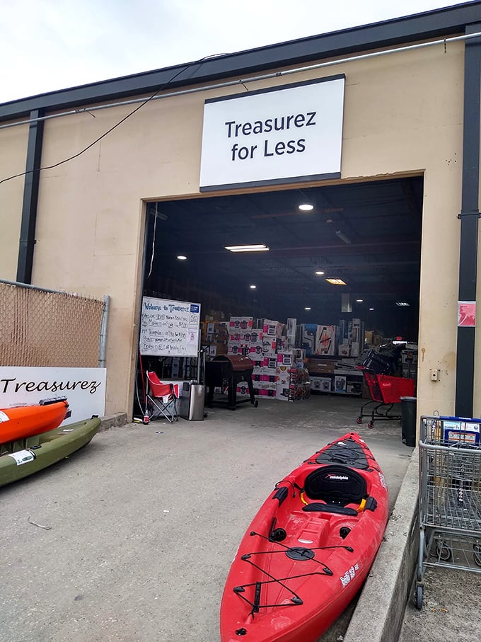 The entrance to Treasurez For Less—where kayaks greet you like red plastic welcome wagons to this bargain hunter's paradise.