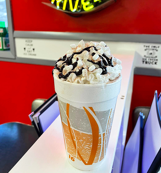 A mountain of whipped cream atop a chocolatey avalanche. This isn't just a shake—it's what happiness would look like if it took liquid form.