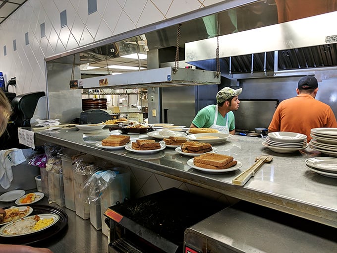 The kitchen pass—where breakfast dreams become reality and short-order cooks perform their morning ballet of eggs and toast.
