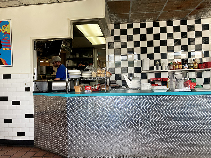 Behind the diamond-plate counter, culinary magic happens without pretense – just decades of know-how and well-seasoned equipment.