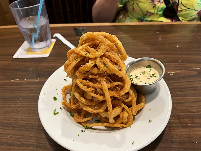 Onion rings stacked higher than a Florida condo development—crispy, golden monuments to the art of simple pleasures done extraordinarily well.